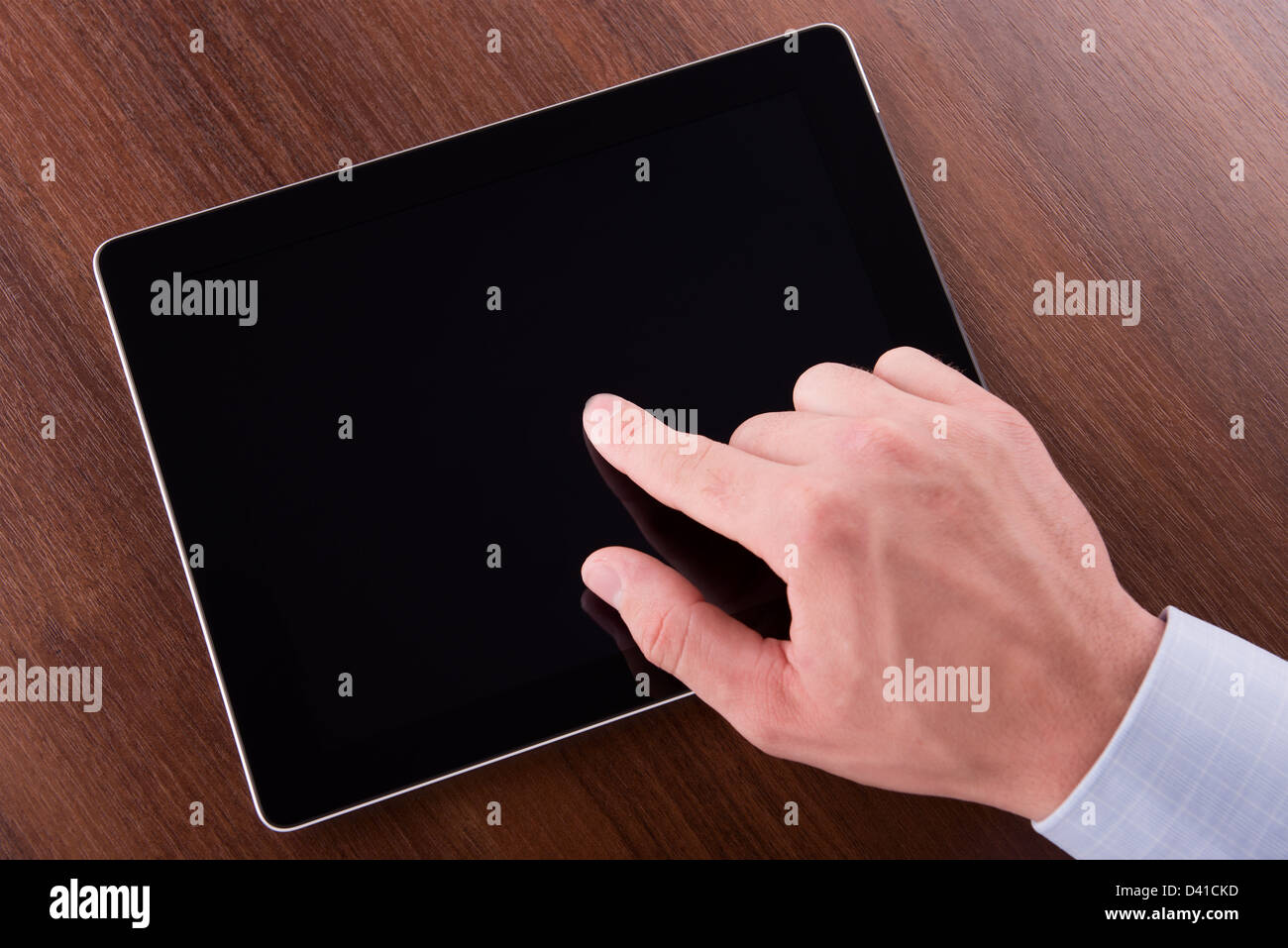 hand on a touch screen of tablet pc, black screen Stock Photo - Alamy
