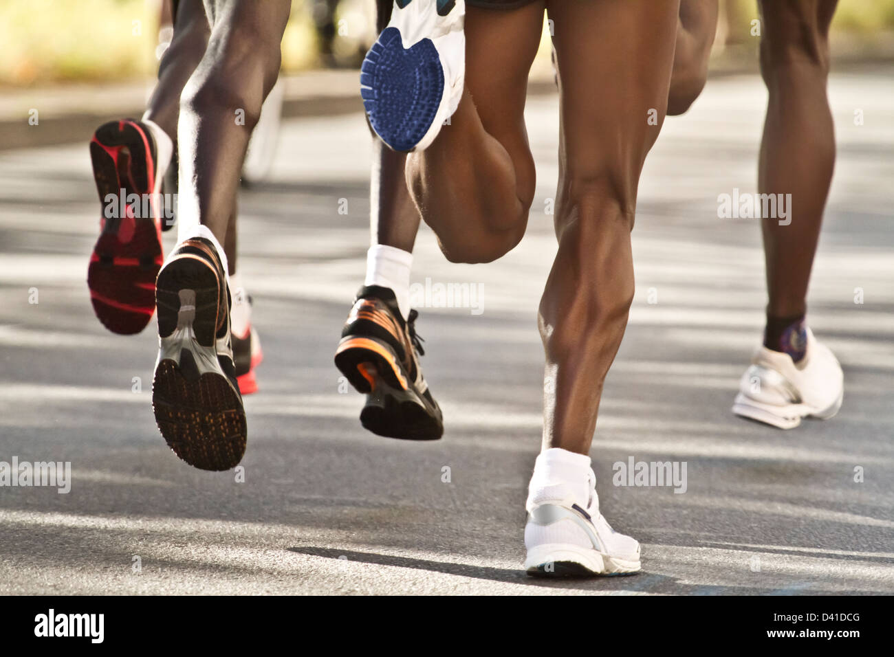 Black marathon runners swinging steps Stock Photo - Alamy