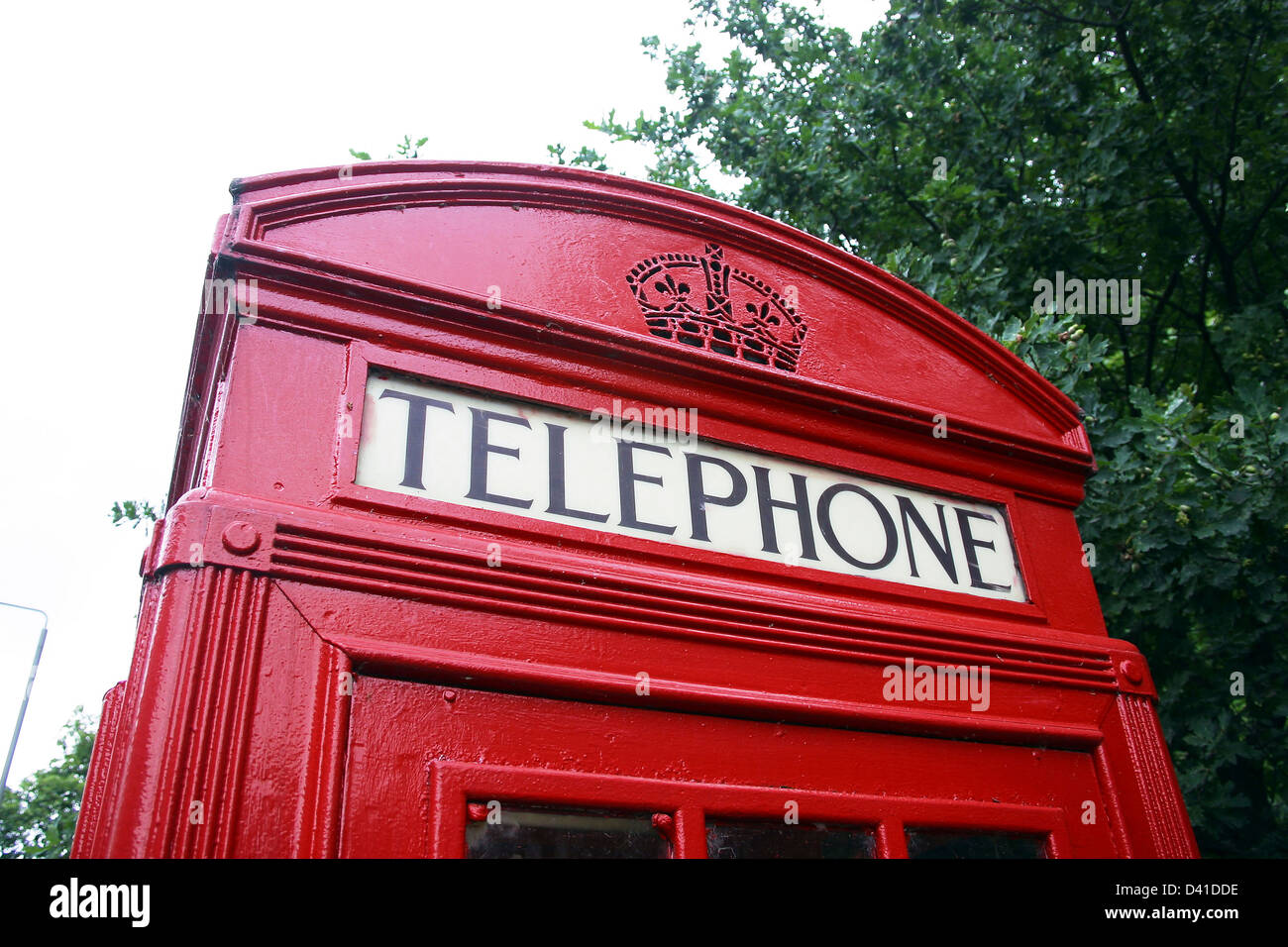 Detail of red telephone box showing domed roof, sign and royal crown ...