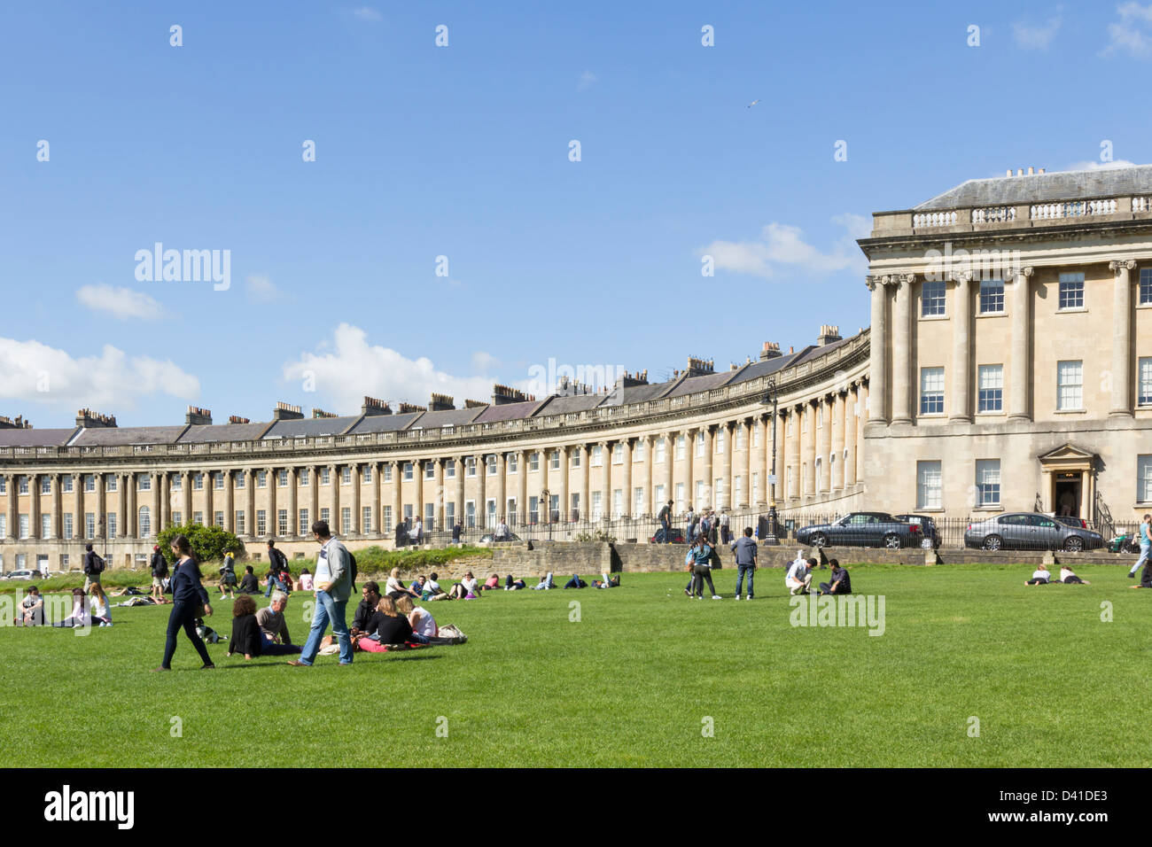 Visitors relax on the lawn near the Royal Crescent, Bath, the curved ...