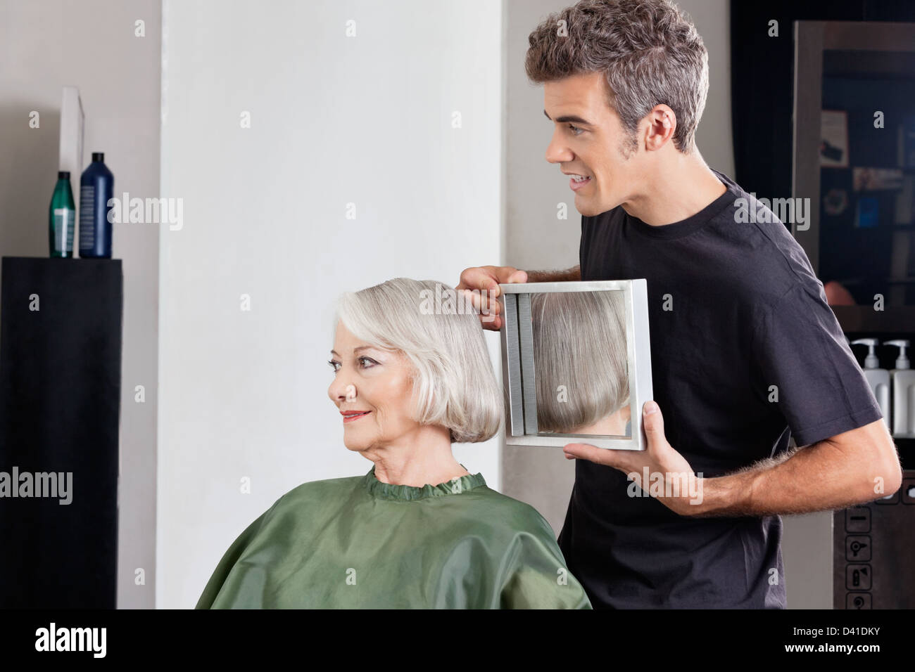 Hairstylist Showing Finished Haircut To Customer At Parlor Stock Photo ...