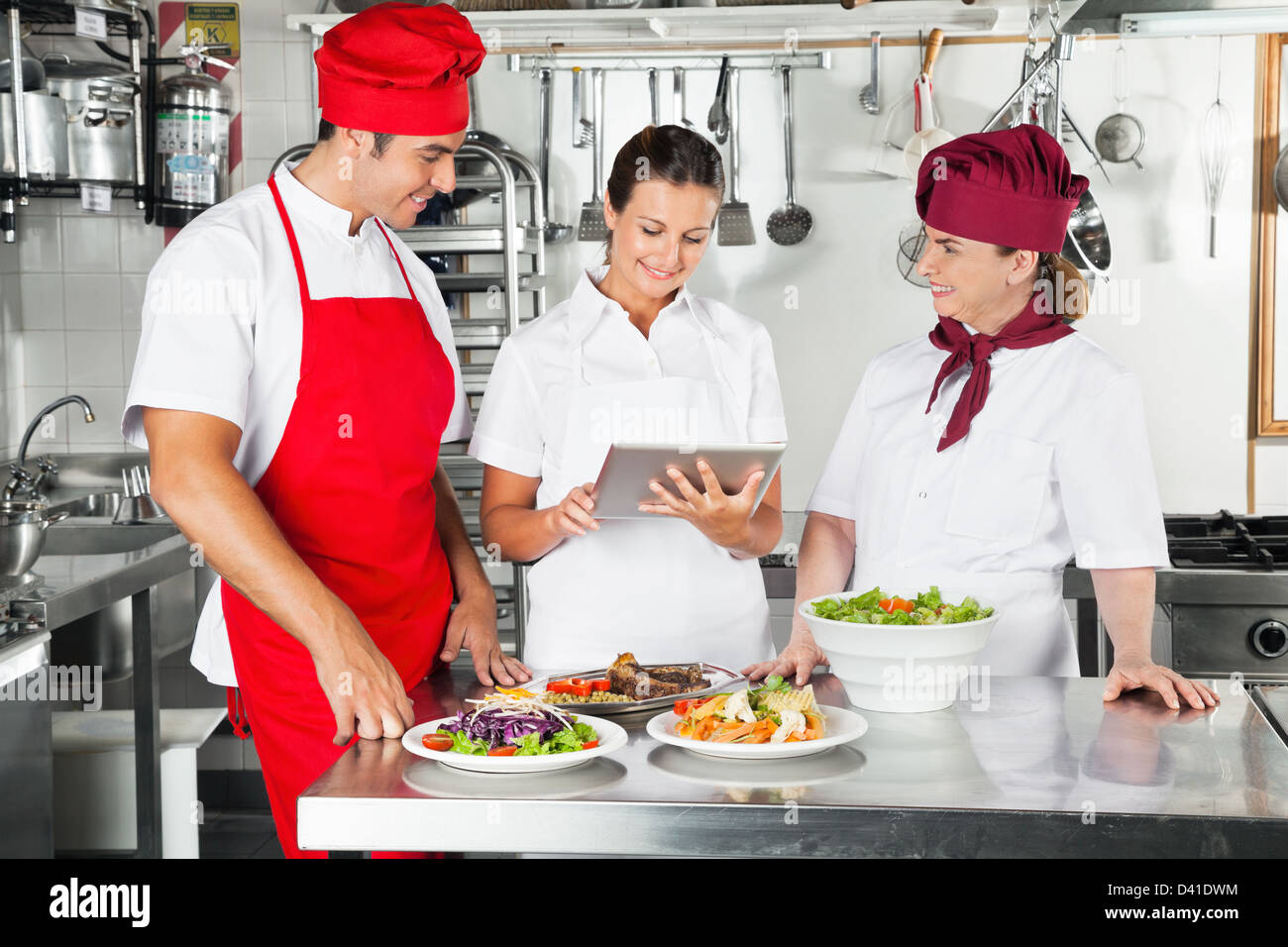 Chefs Using Tablet Computer In Kitchen Stock Photo - Alamy