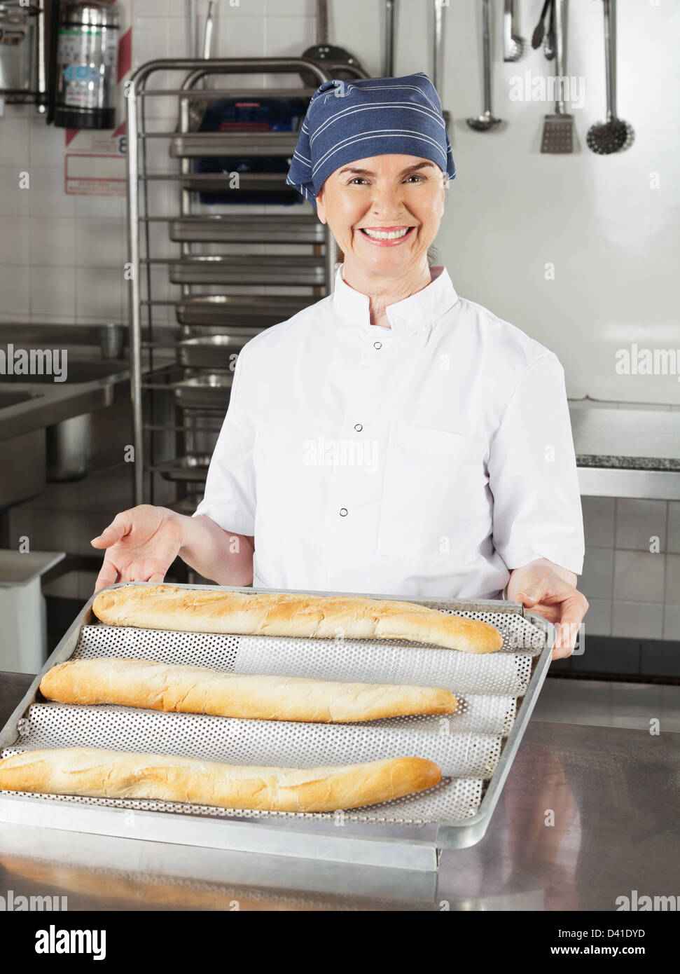 Female Chef Presenting Loafs Of Bread Stock Photo - Alamy