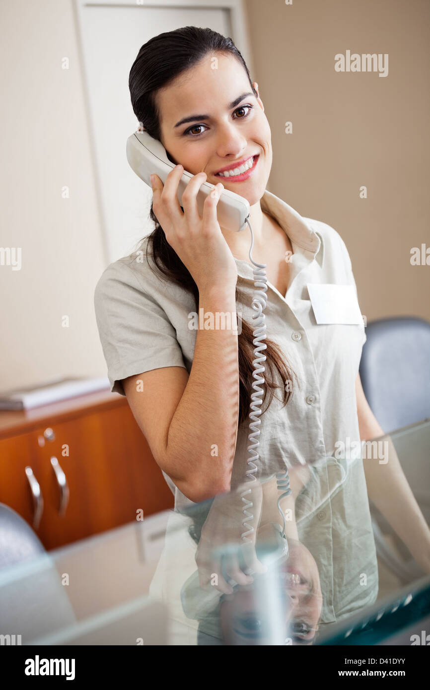 Female Receptionist Attending Call Stock Photo - Alamy