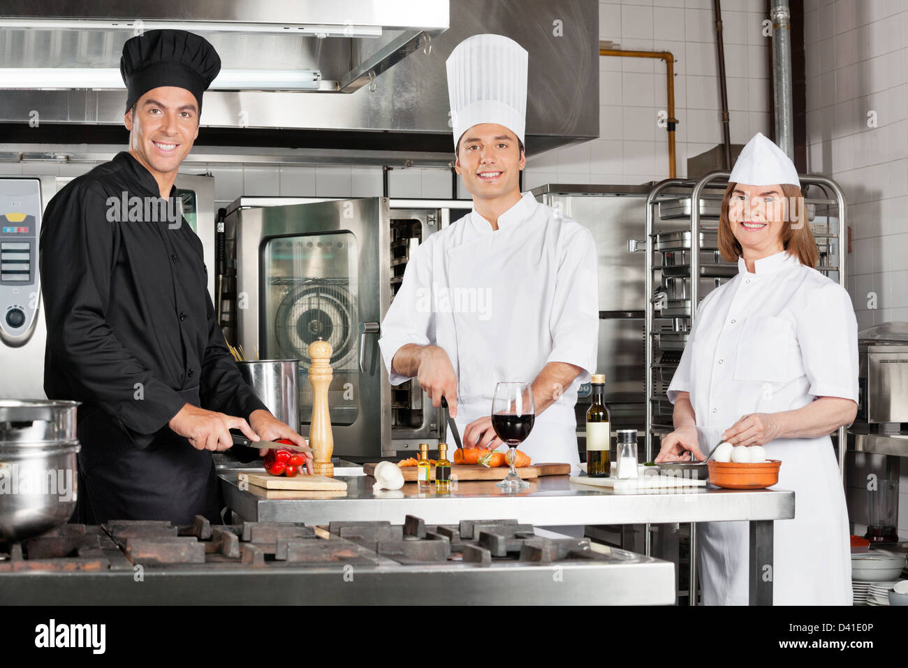 Chefs Working In Industrial Kitchen Stock Photo - Alamy