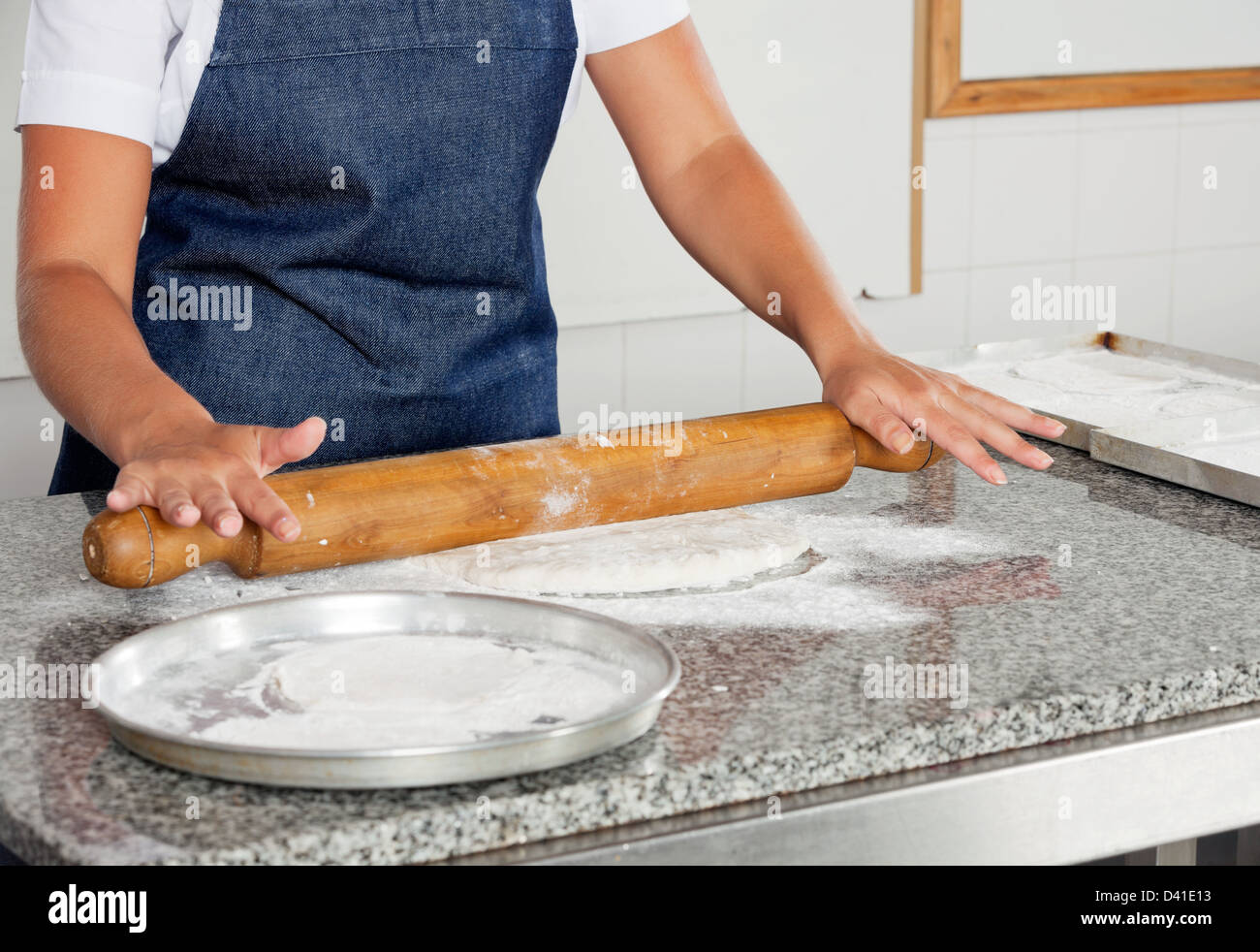 Female Chef Rolling Dough On Counter Stock Photo - Alamy