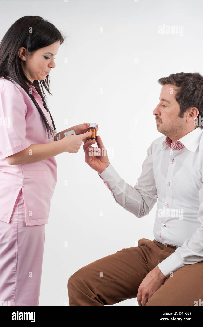 Nurse give pills to patient Stock Photo - Alamy