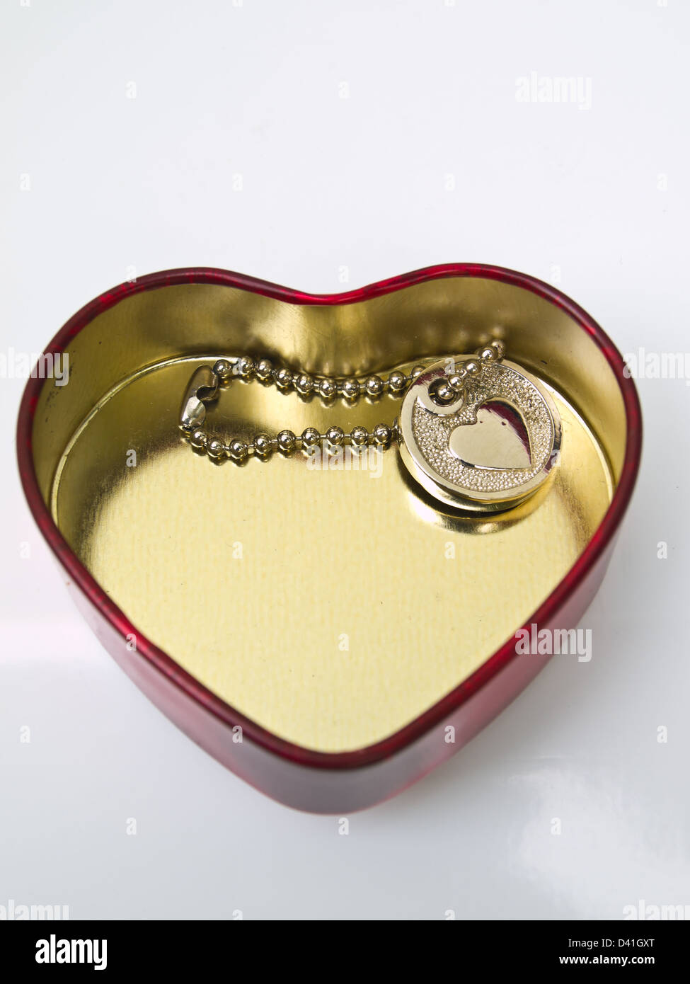 A metallic heart key-chain in stainless heart box isolated on white ...