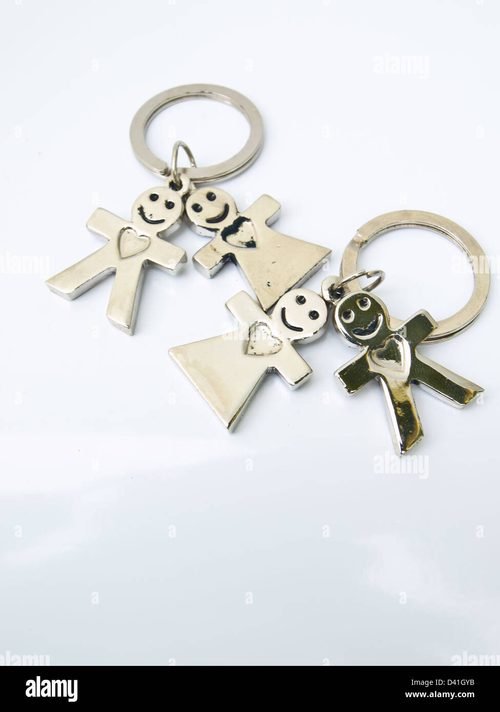 Metallic couple key-chain isolated on white background Stock Photo - Alamy