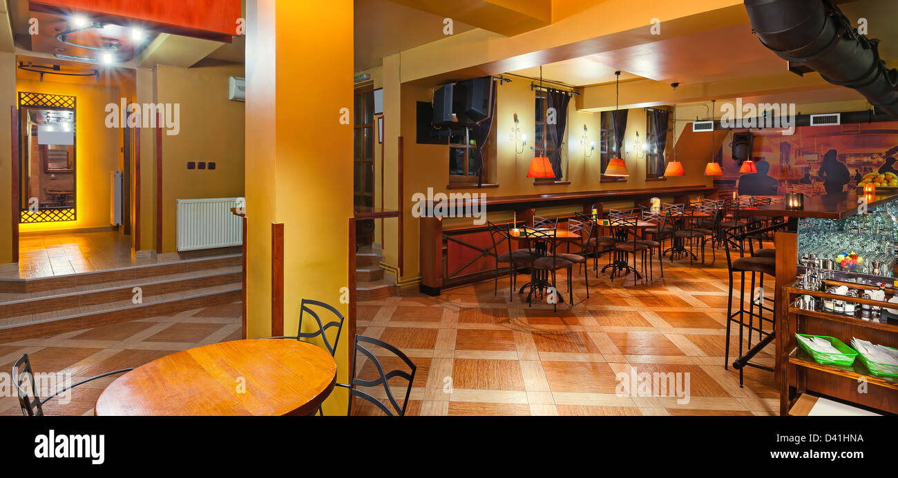 Interior of a modern pub in orange and wooden colors Stock Photo - Alamy