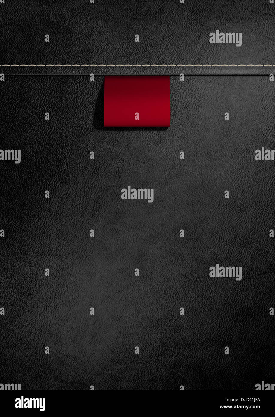 A red woven clothing label sewn into seamed black leather Stock Photo ...
