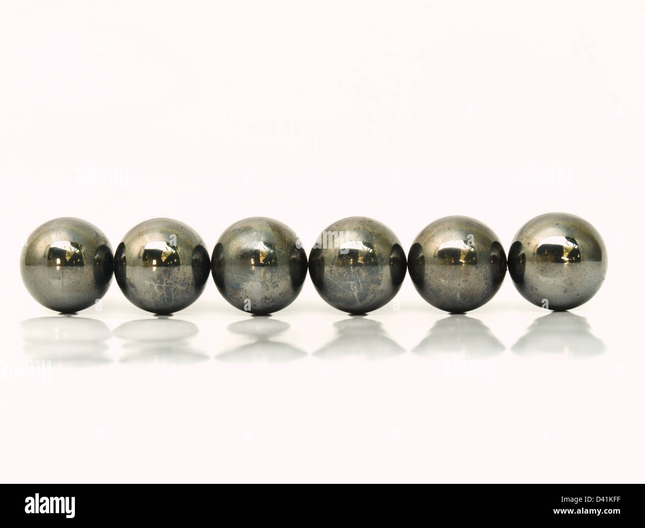 Line of iron metal balls Stock Photo - Alamy