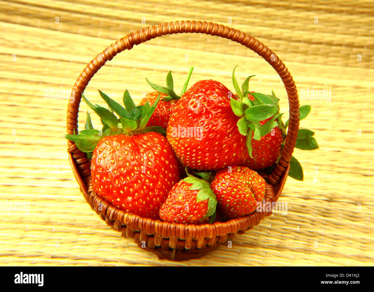 Strawberries in bamboo basket in sunlight Stock Photo - Alamy