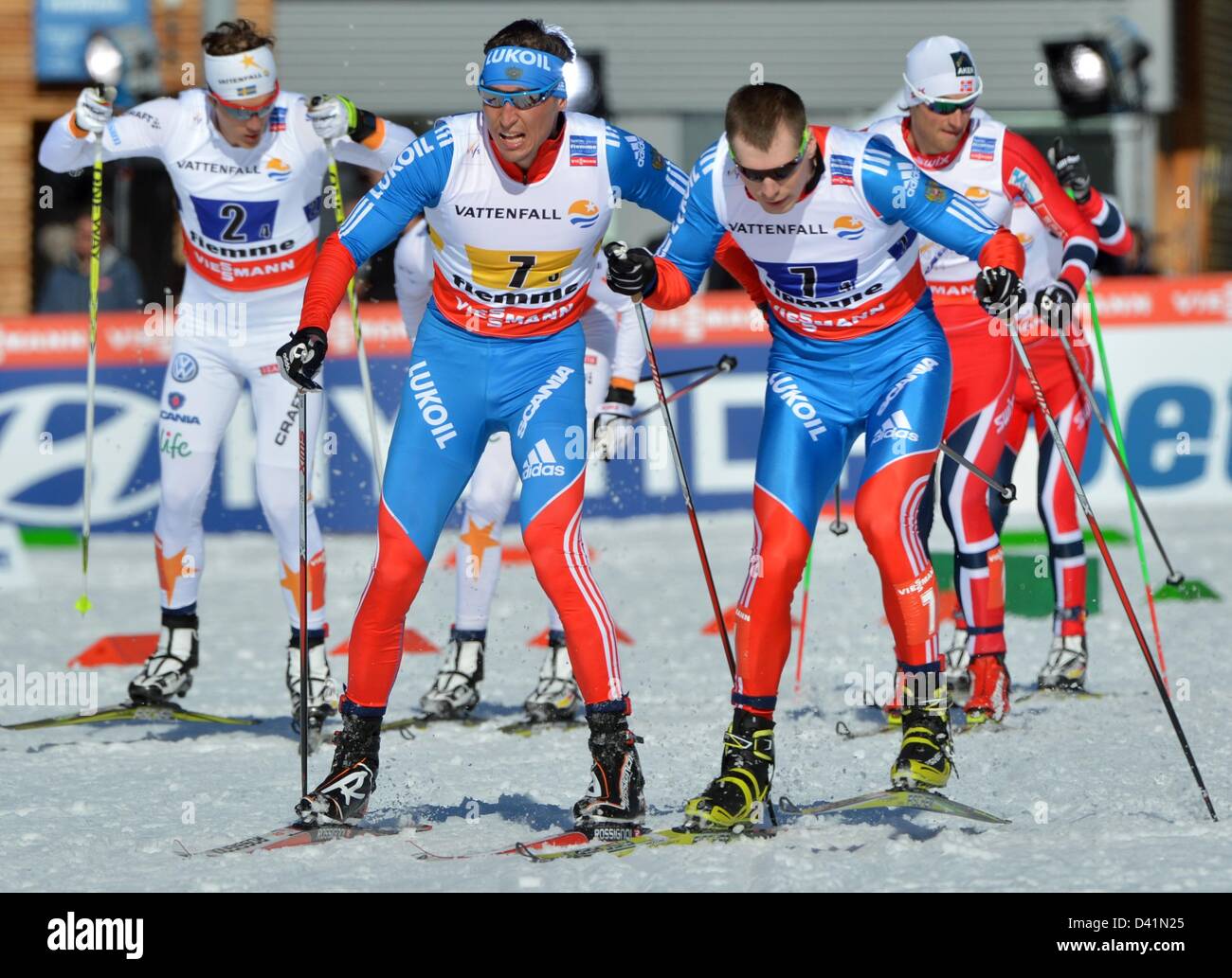 Alexander Legkov (L) and Sergey Ustiugov of Russia compete during the ...