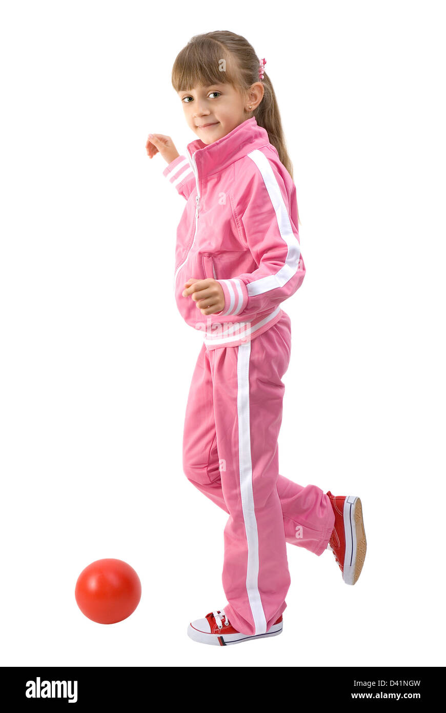 The little girl in a pink sports suit plays with a red ball Stock Photo ...