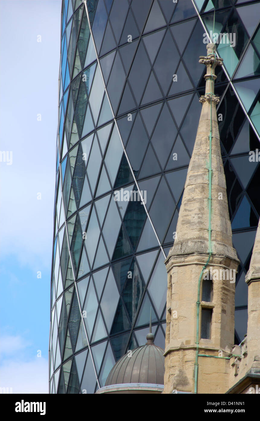 Church spire and the Gherkin skyscraper in the City of London, England ...