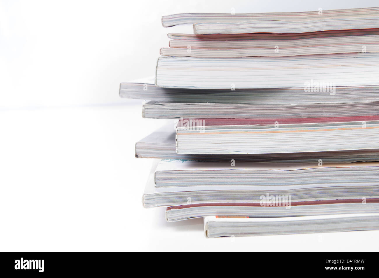 Stack of magazines on white Stock Photo - Alamy