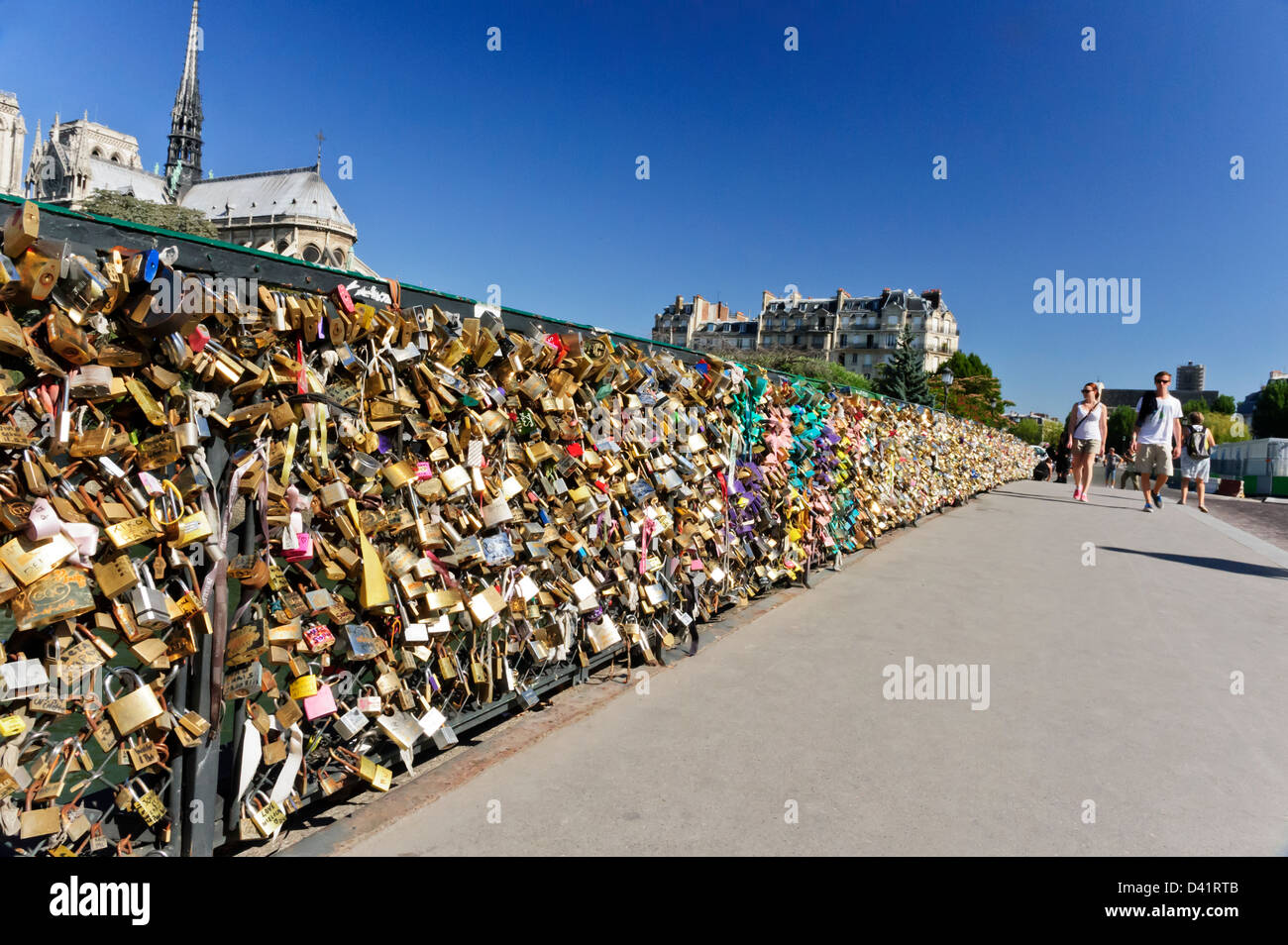 Locks of all sizes and types cover railings of l'Archevêché bridge ...