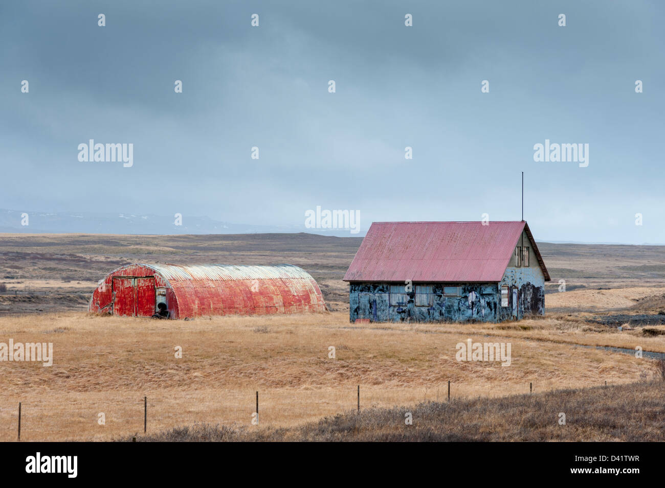 Landscape with Two corrugated barns near Geysir Iceland with dark moody ...