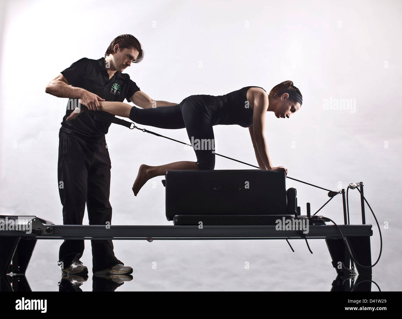 Personal trainer instructing man at gym hi-res stock photography and ...