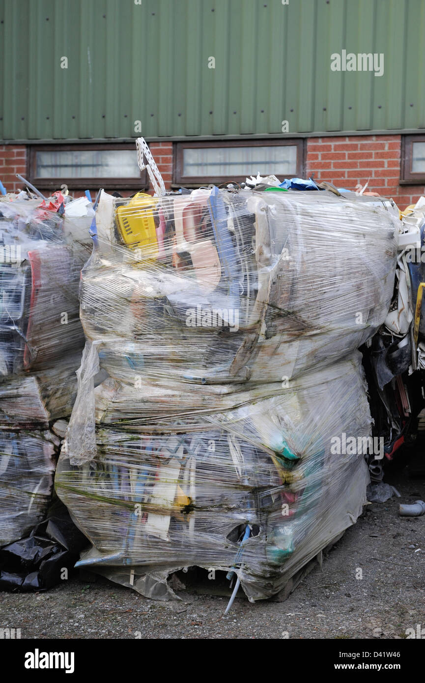 Cardboard recycling at recycling plant. Cardboard compressed in a bale ...