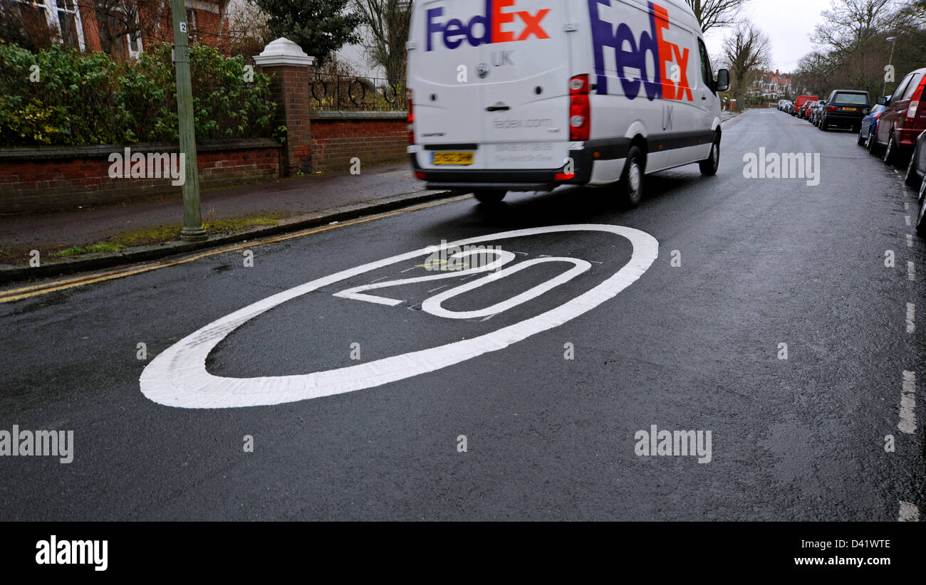 Van driving over one of the new 20 mph speed limit road marking signs ...
