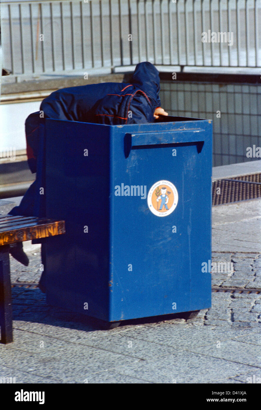 Berlin, GDR, man rummaging in a dumpster Stock Photo - Alamy