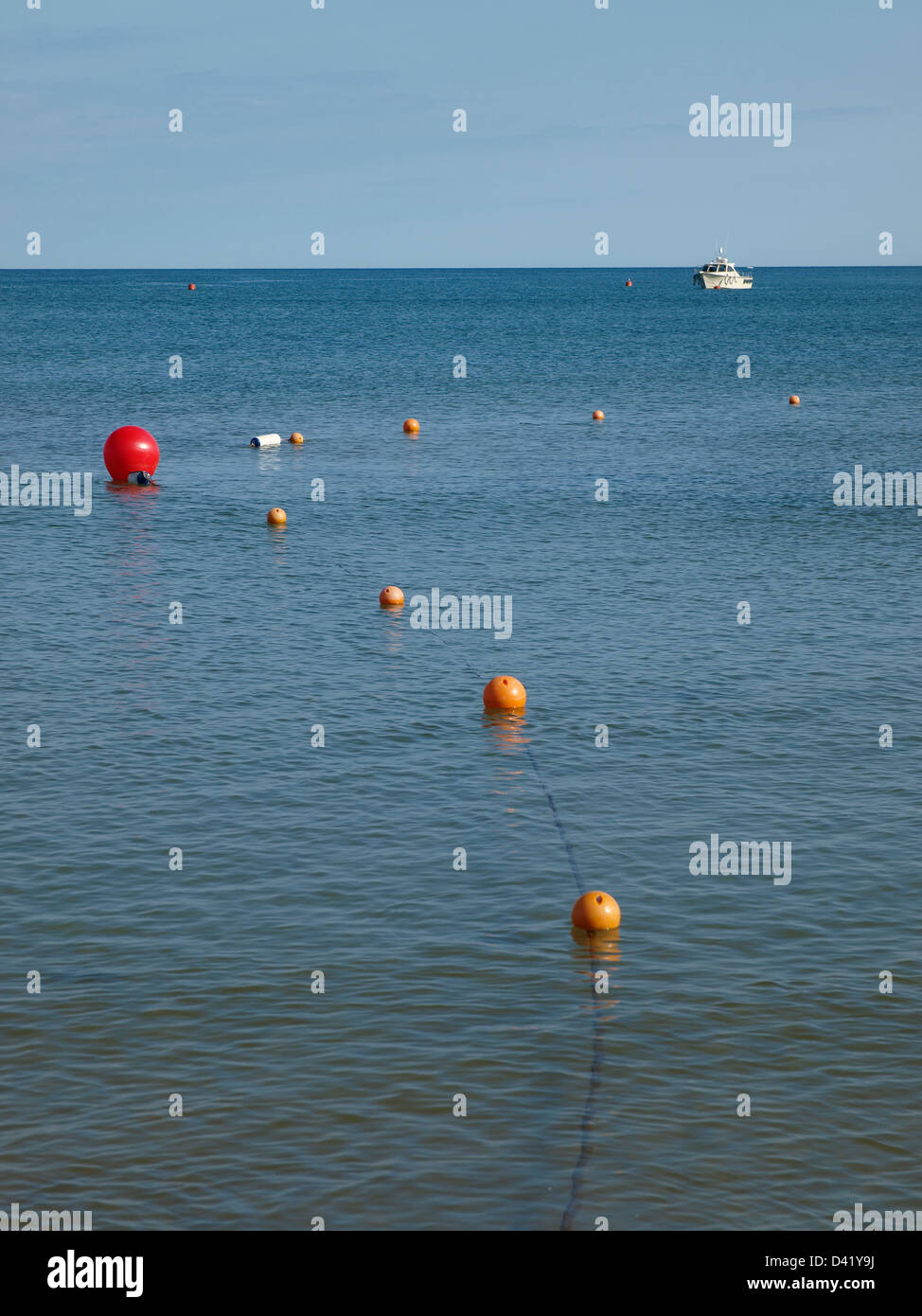a line of yellow and red buoys on calm sea Stock Photo - Alamy