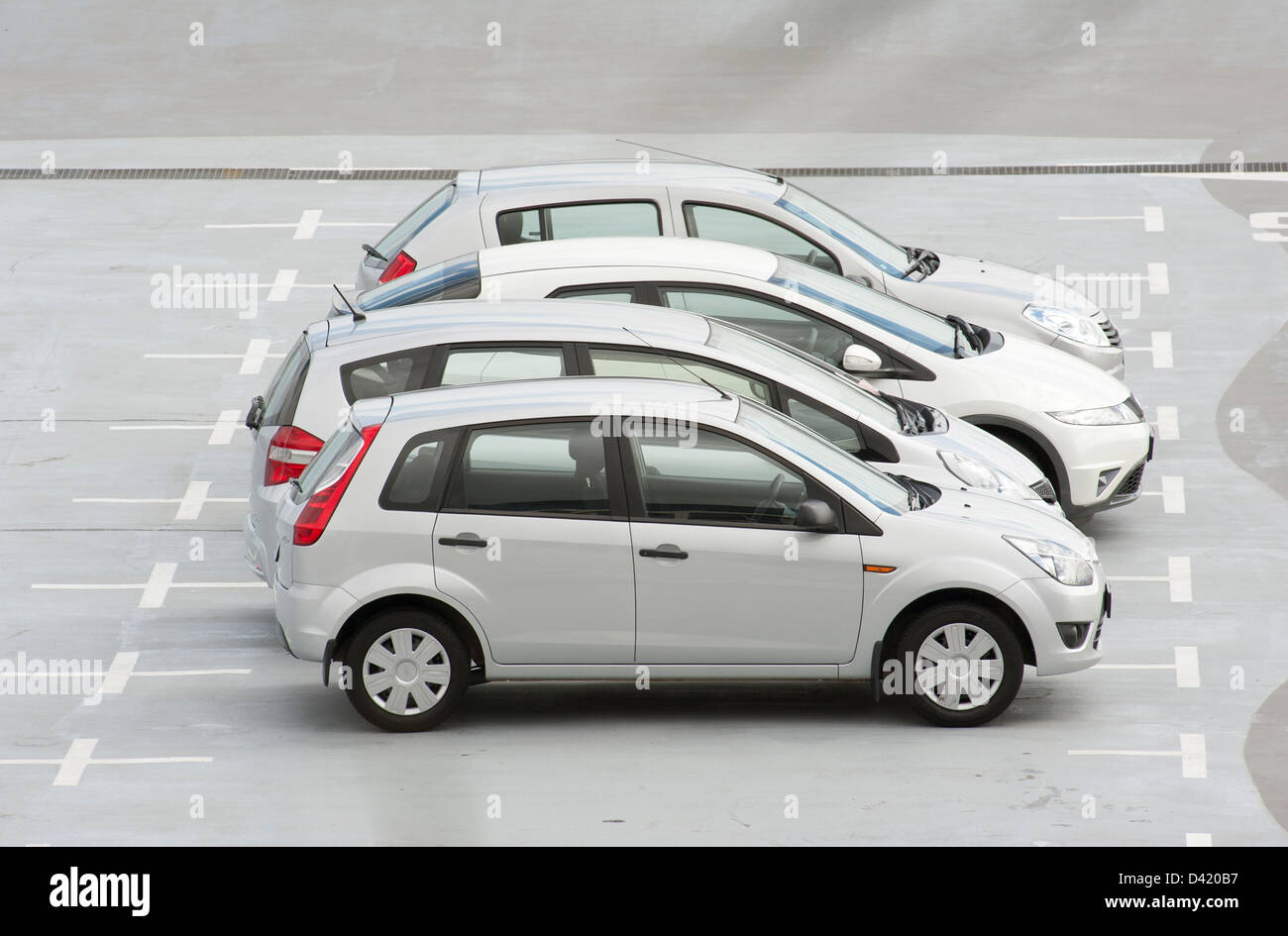 Parked cars in designated spaces of a car park Stock Photo - Alamy