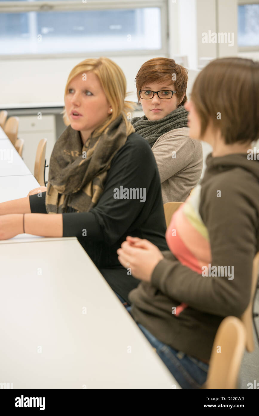 A couple of female students study in university, discuss and listen ...
