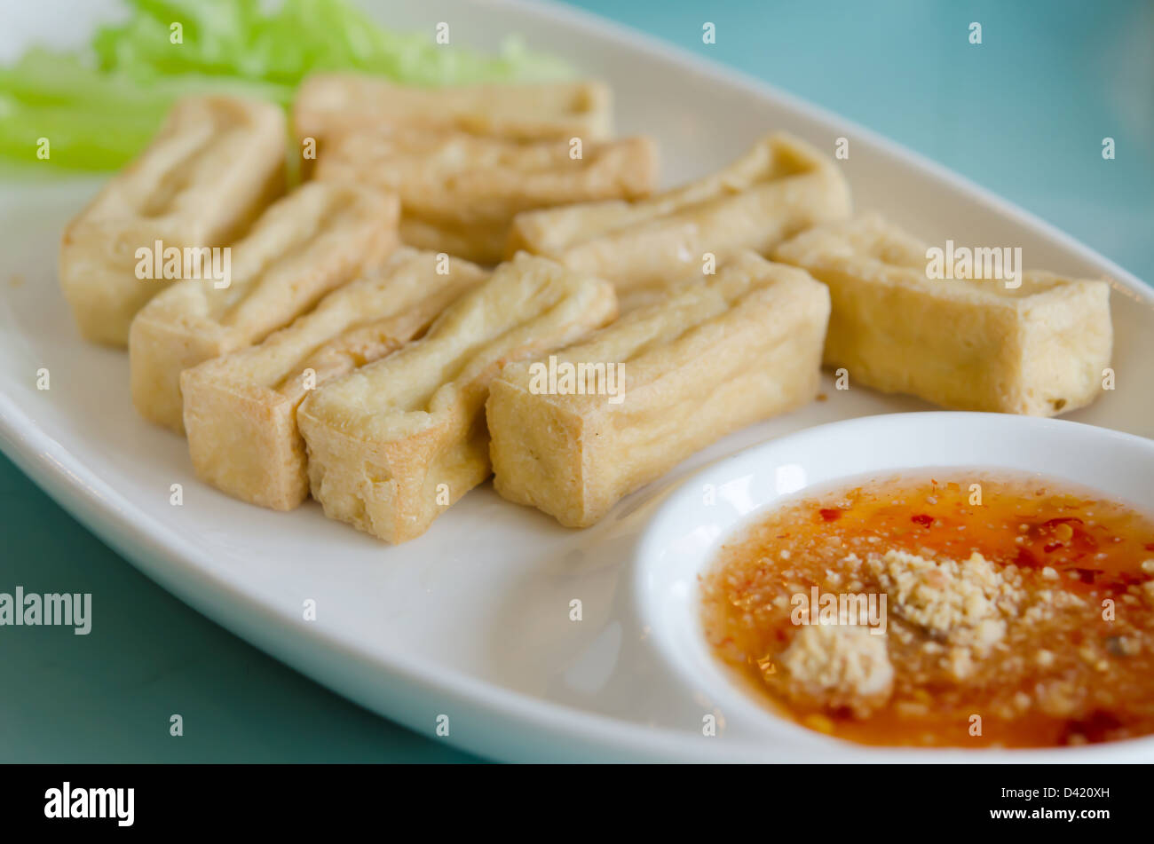 deep fried tofu served with fresh lettuce and spicy sauce Stock Photo ...