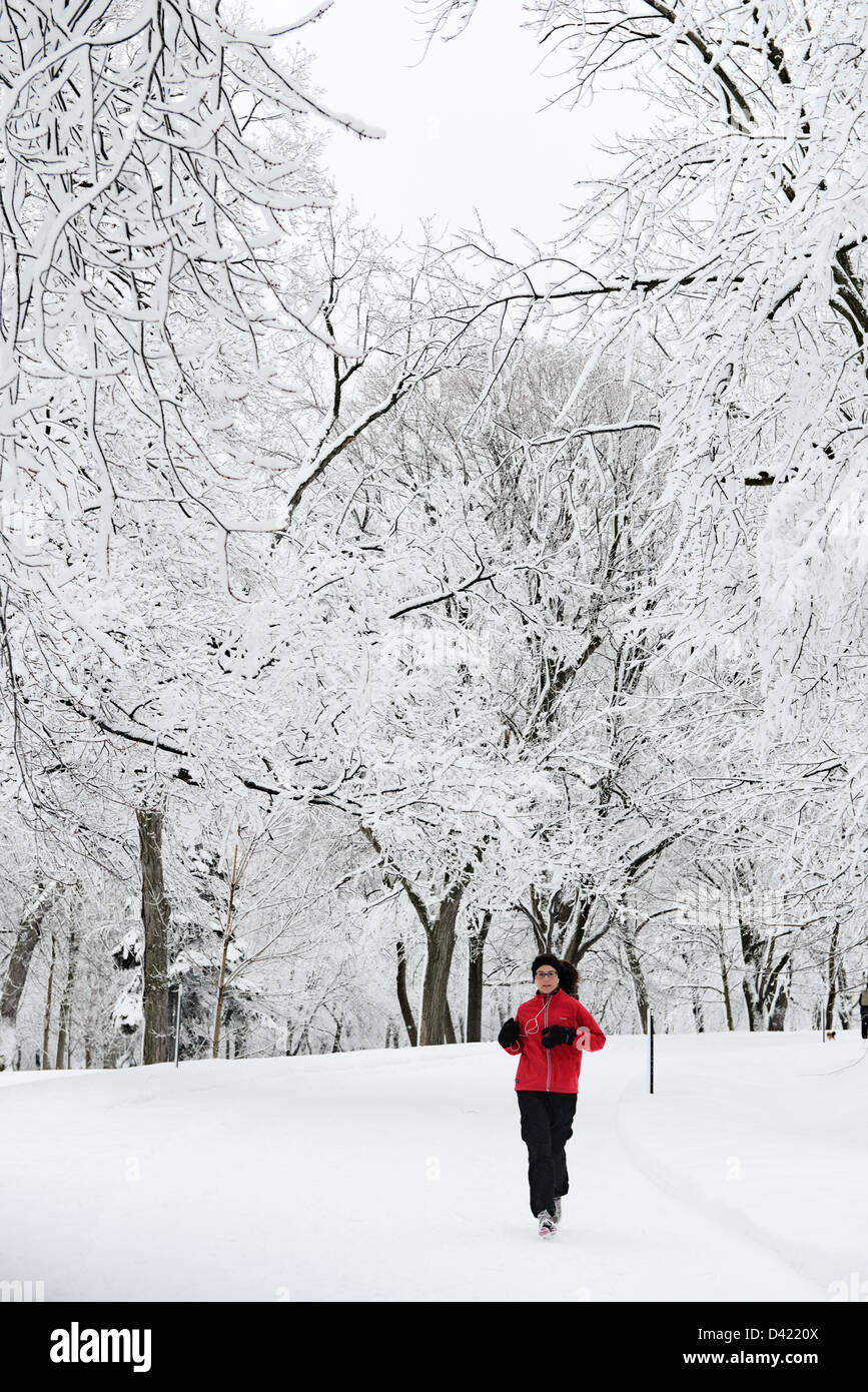woman running in a Snow covered Mont Royal Park in Winter, Parc du Mont ...