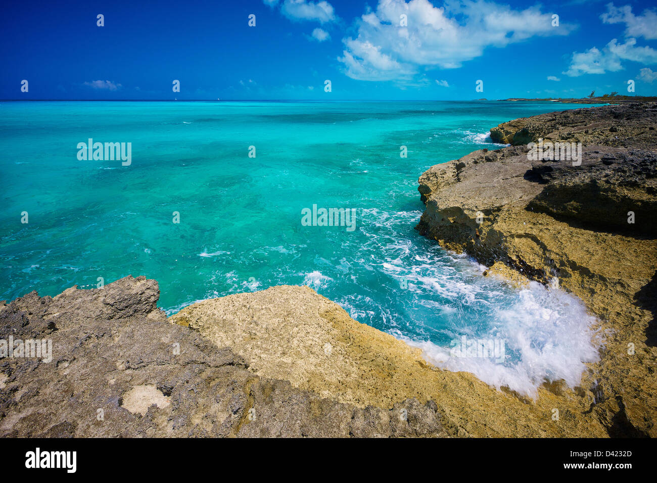 The Caribbean sea erodes away at a seaside cliff on Exuma Island ...