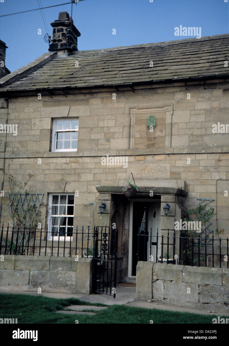 Traditional stone house in Yorkshire with cast-iron railings on low ...