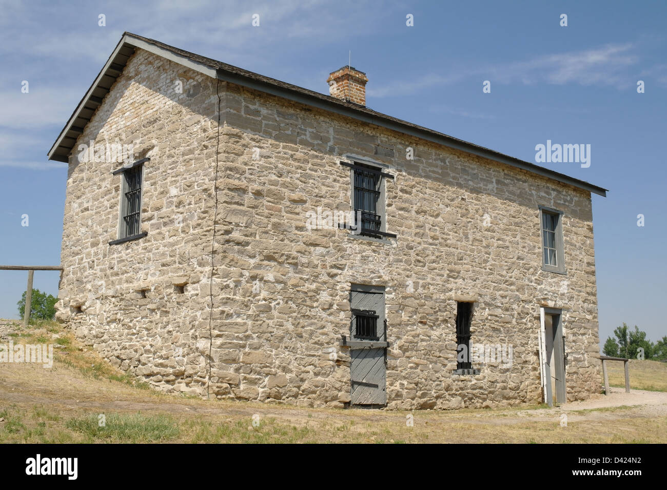 Blue sky view barred windows, doors 1866 stone guardhouse building ...