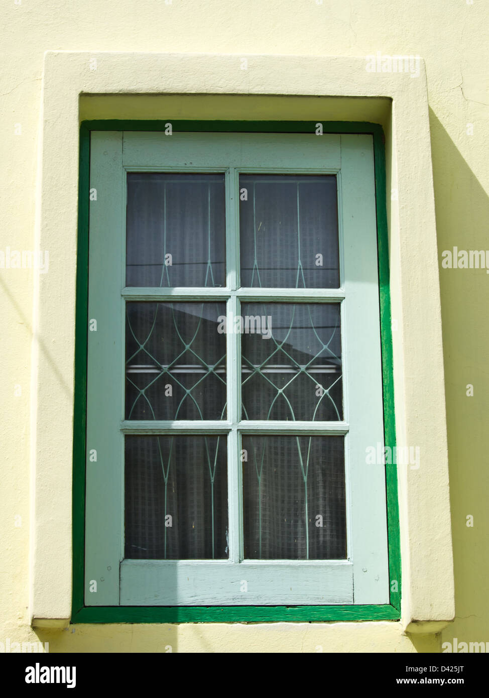 A light blue closed French panel window on yellow wall Stock Photo - Alamy