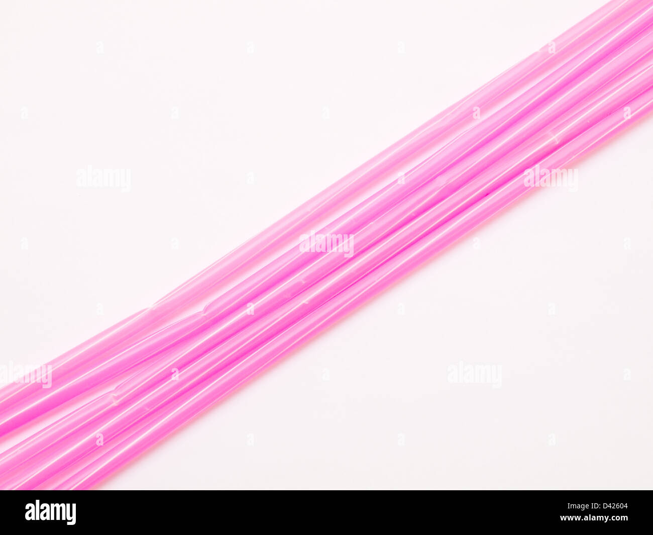Pink straws isolated on white background Stock Photo - Alamy