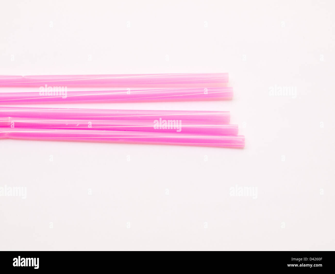 Pink straws isolated on white background Stock Photo - Alamy