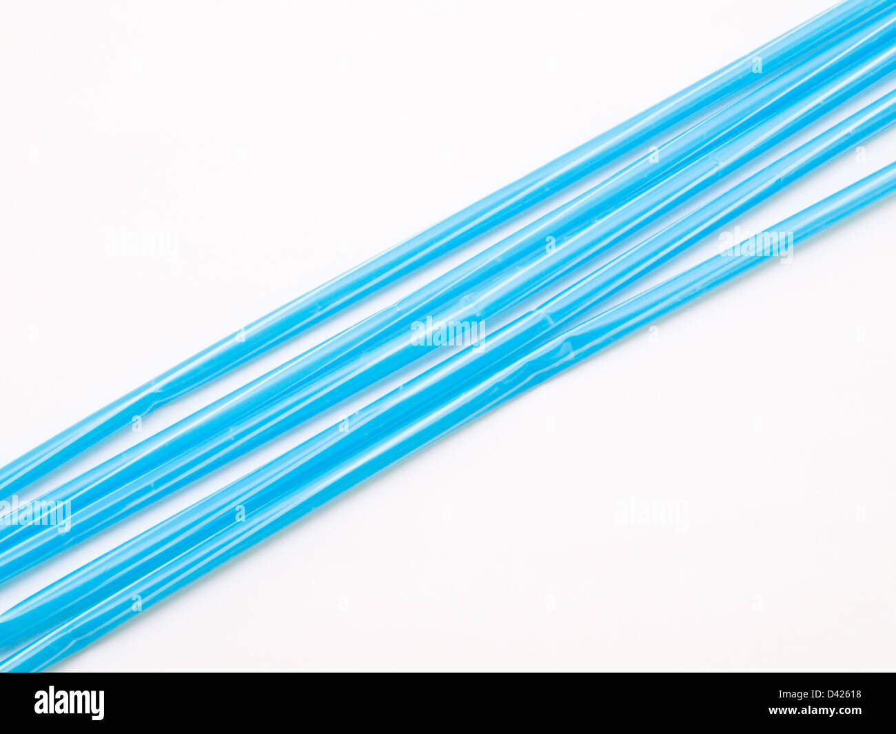 Light blue straws isolated on white background Stock Photo - Alamy