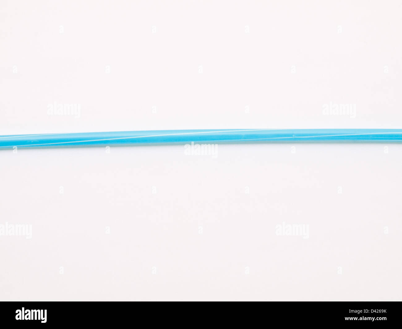Light blue straw isolated on white background Stock Photo - Alamy
