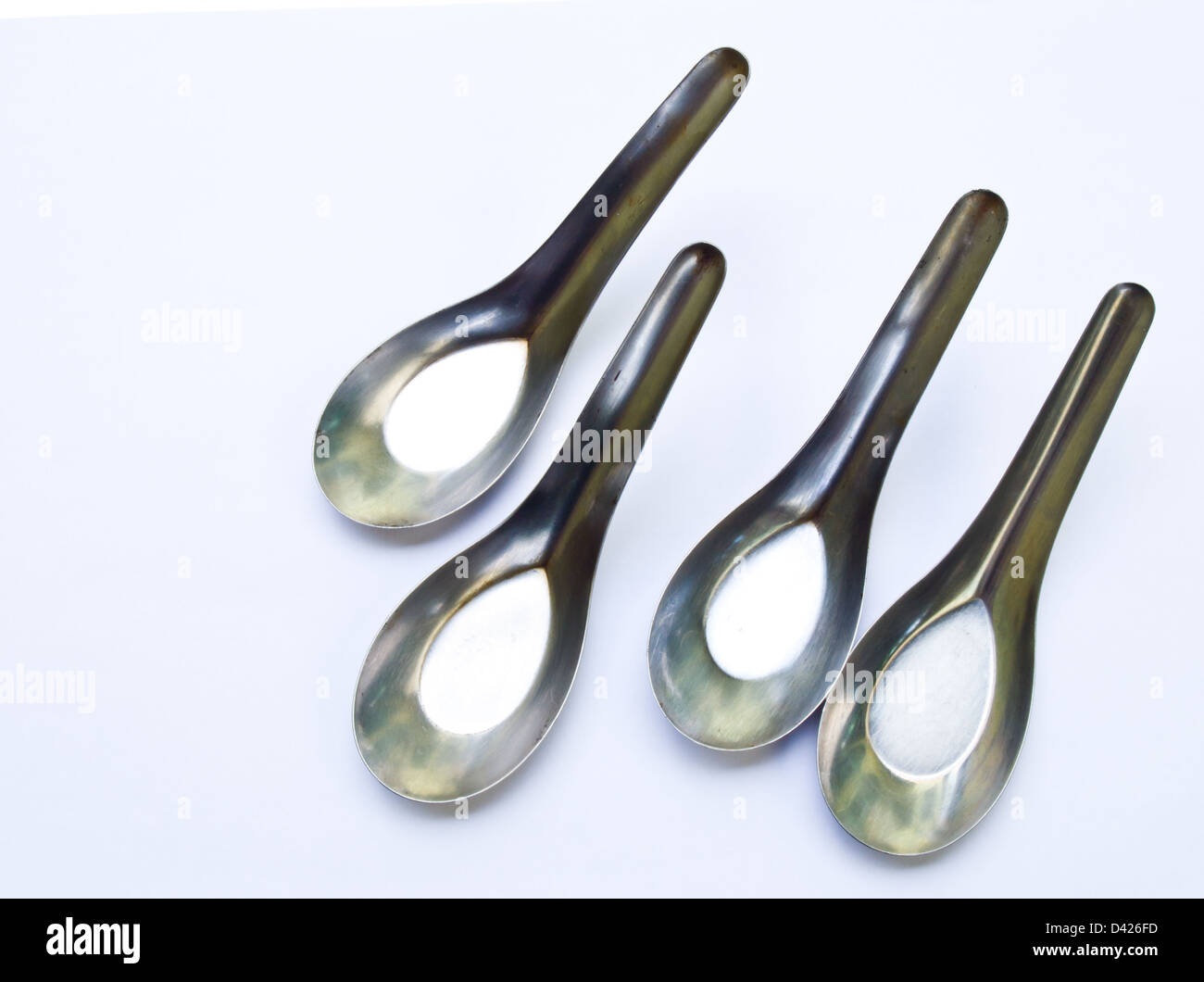 Used stainless steel spoons isolated on white background Stock Photo ...