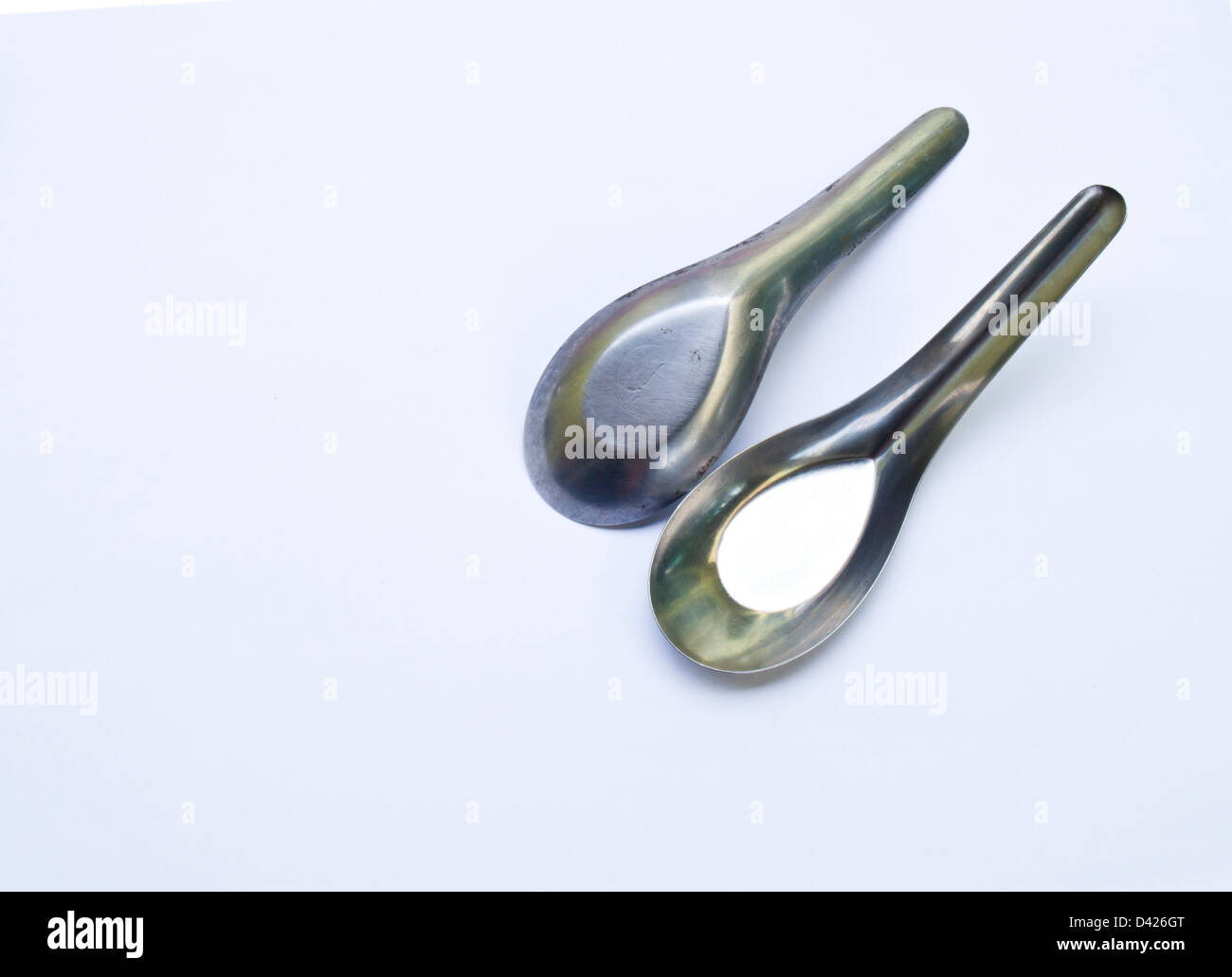 Used stainless steel spoons isolated on white background Stock Photo ...