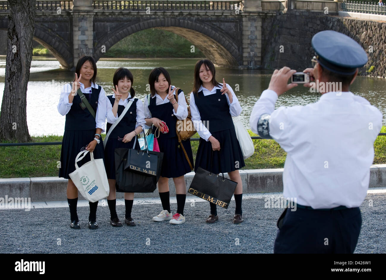 Security guard taking commemorative photo of high school girls at Tokyo ...