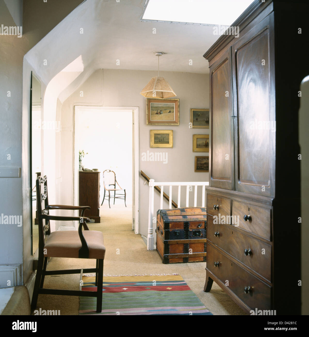 Antique linen press and sofa on landing of country house Stock Photo ...