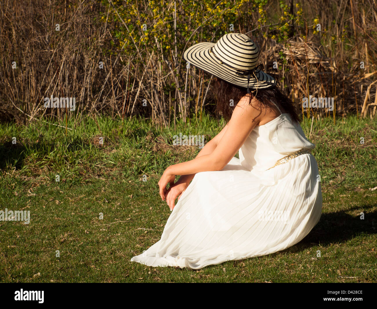 Young woman in white dress with open hands Stock Photo - Alamy