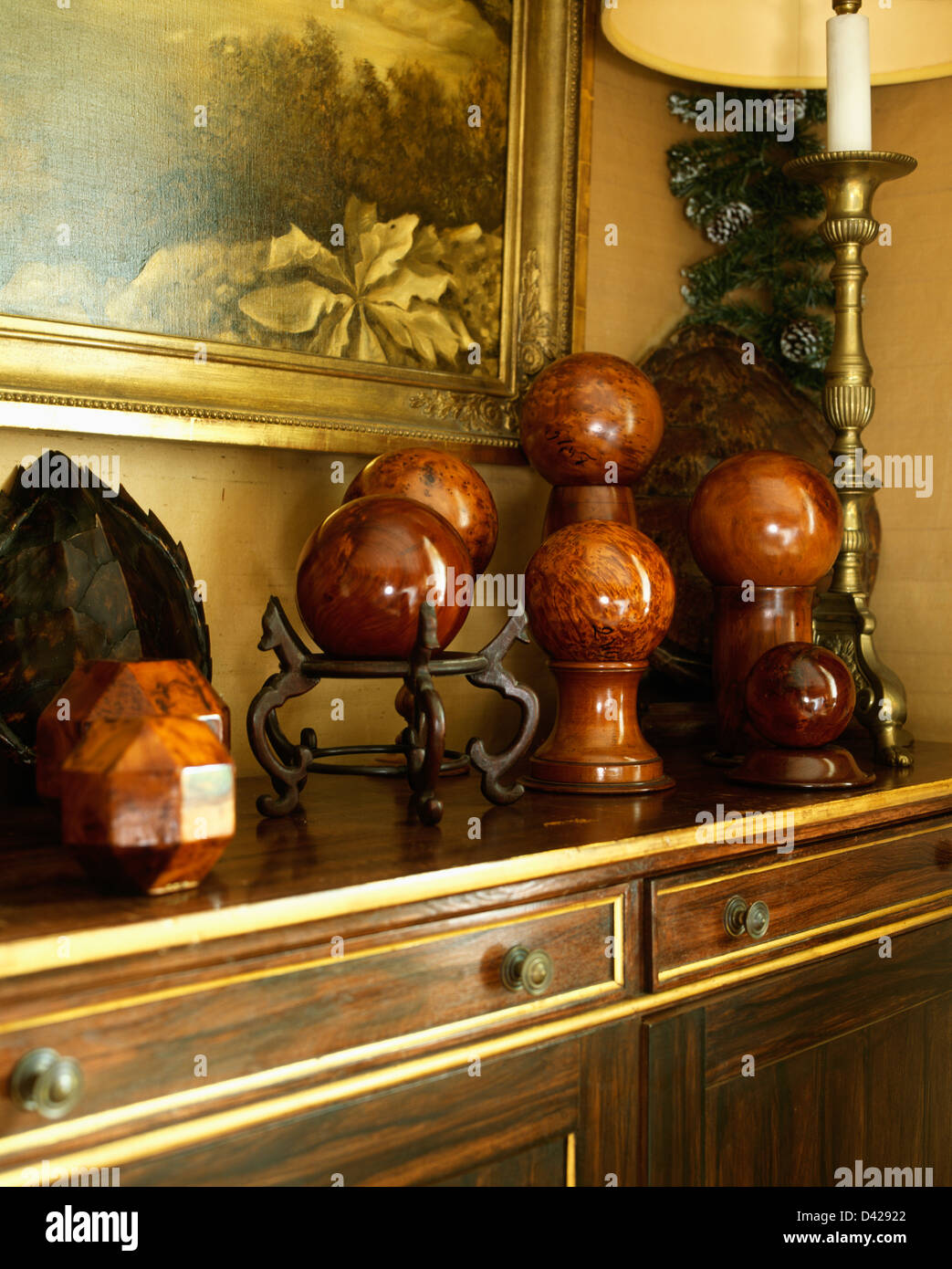 Close-up of collection of polished, antique wooden balls on cupboard ...