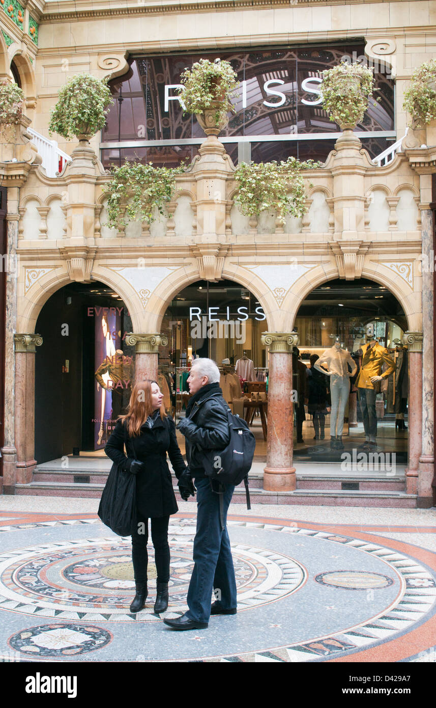 Couple standing outside Reiss store within County Arcade Leeds, England ...