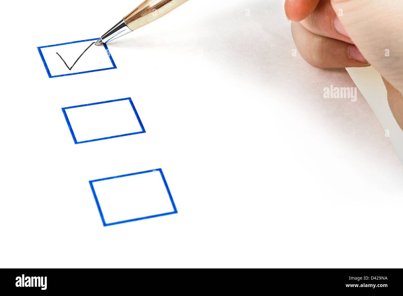 put tick in blue square box by metal gold pen Stock Photo - Alamy