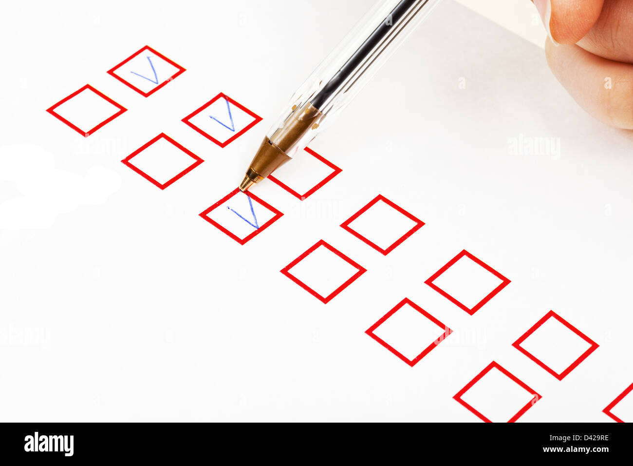 tick in red square box by blue plastic pen Stock Photo - Alamy