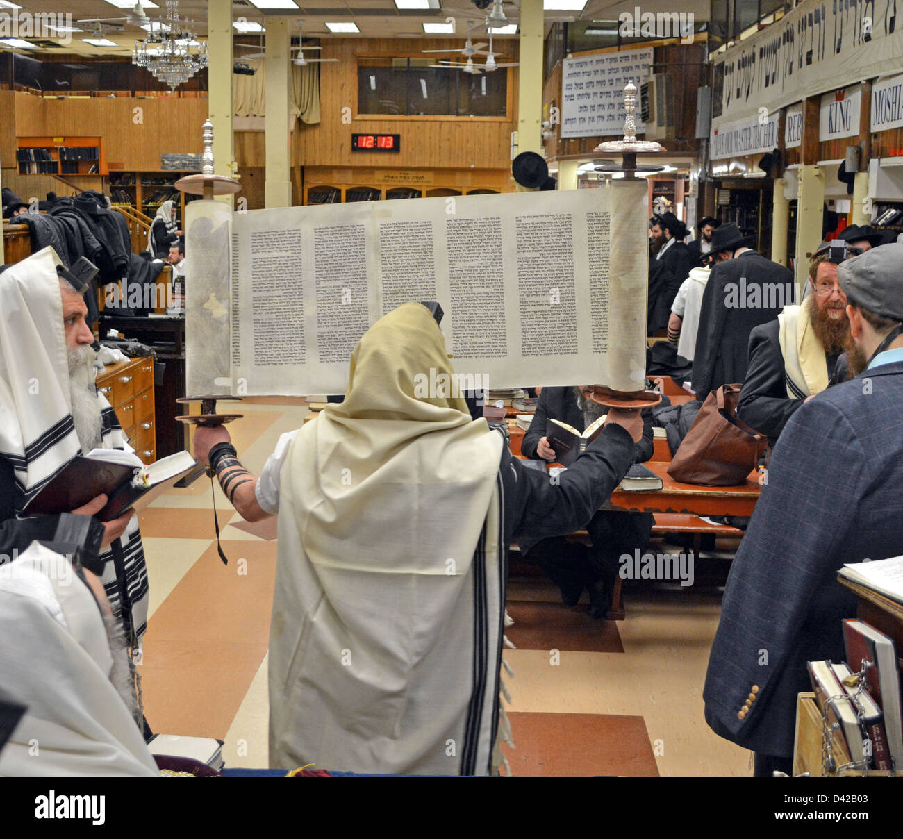 Worshiper holding up a Torah after a reading at morning services at the ...